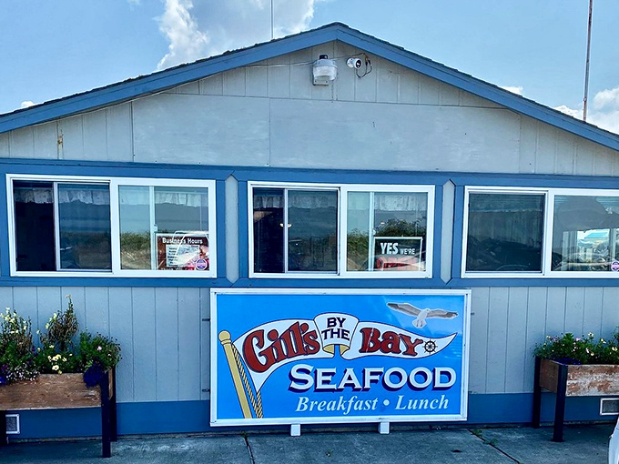 The classic blue-and-white exterior of Gill's By the Bay looks like a postcard from coastal California that accidentally became a restaurant.