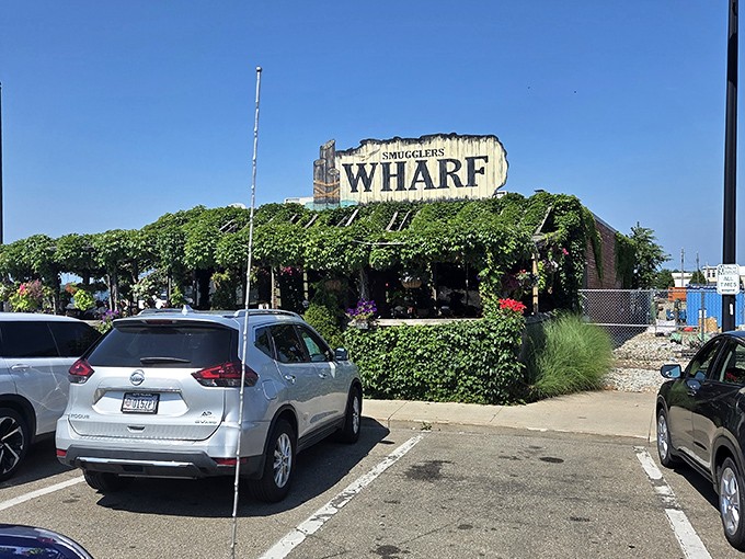 Nature's slowly reclaiming this maritime treasure, with vines embracing the weathered sign like old friends reuniting at a high school reunion.