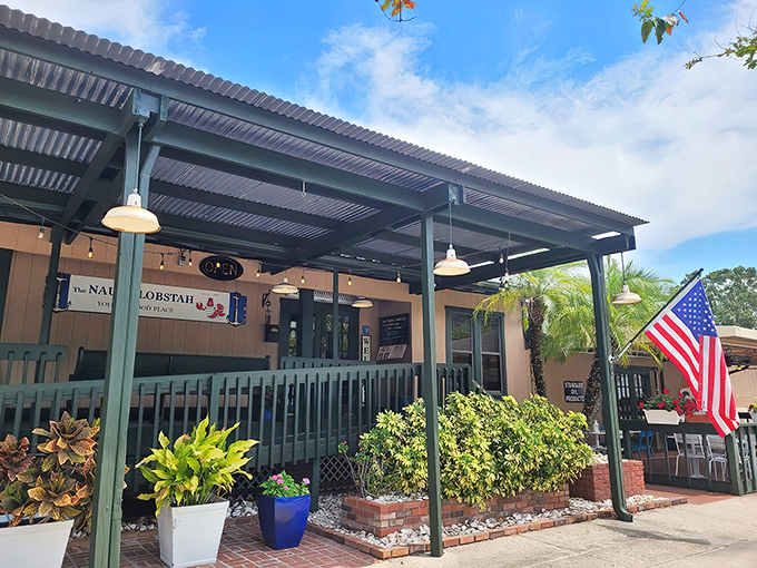 The coastal charm hits you before you even step inside. That mint-green fence and beachy sign promise New England vibes in the heart of Florida.