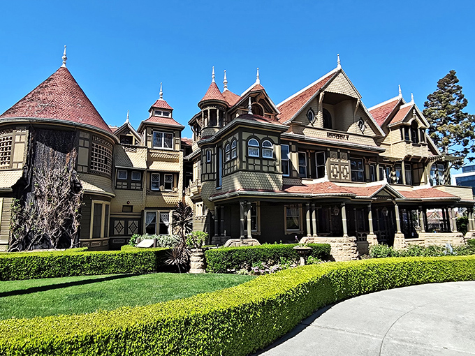 The Winchester Mystery House stands as a Victorian fever dream, its turrets and towers reaching skyward like architectural question marks against the California blue.