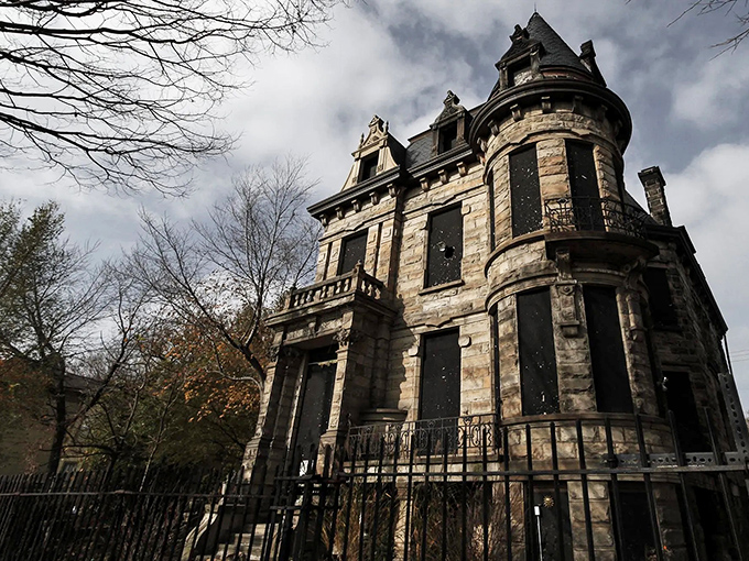 The imposing stone facade of Franklin Castle looms against a moody sky, its turrets and balconies whispering tales of Cleveland's Gothic past.