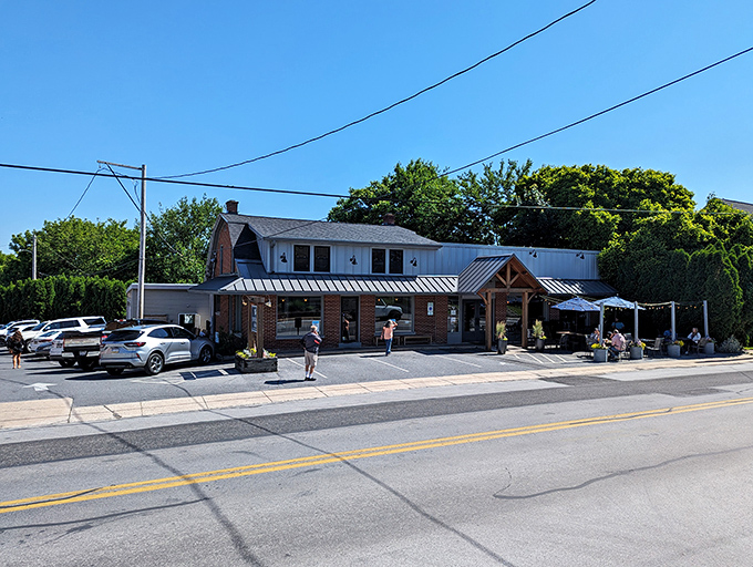 The blue exterior of Speckled Hen beckons like a culinary lighthouse on Strasburg's Main Street, complete with charming wooden accents and inviting outdoor seating.