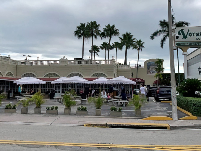 The iconic green-lettered sign of Versailles Restaurant stands proudly above its white fa&ccedil;ade, a beacon of Cuban culinary tradition in Miami's Little Havana.