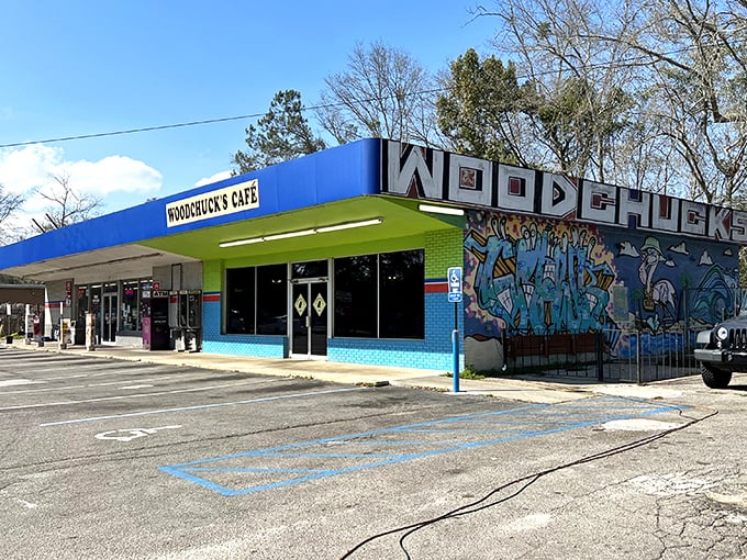 The vibrant blue and green exterior of Woodchuck's Cafe stands out like a tropical oasis in Tallahassee, complete with eye-catching mural that screams "we're not your average diner."