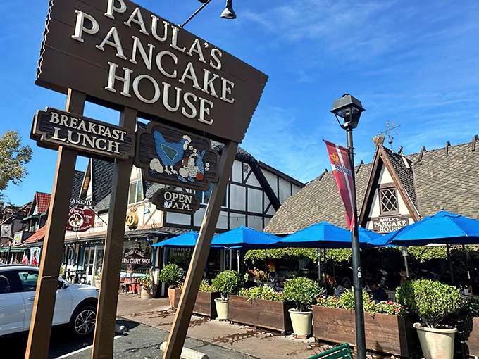 The iconic wooden sign beckons breakfast lovers like a siren call. Danish architecture and blue umbrellas promise a European morning in California wine country.