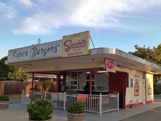 The classic red and white façade of Snow White Drive-In stands like a time capsule in Lodi, beckoning hungry travelers with its "Super Burgers" promise.