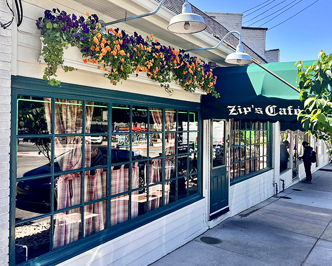 The charming exterior of Zip's Cafe welcomes you with colorful flower boxes and that iconic green awning&mdash;a Cincinnati landmark that promises comfort without pretension.