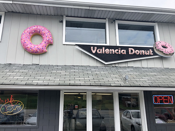 Those giant pink donuts flanking the storefront aren't just decoration—they're beacons of hope for the sugar-deprived traveler on Route 8.