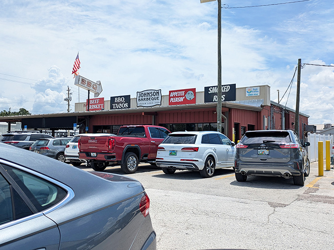 The neon glow of Johnson Barbeque's signage cuts through the night like a beacon for hungry souls. BBQ tacos, beef brisket, and smoked ribs—the signs tell you everything you need to know.