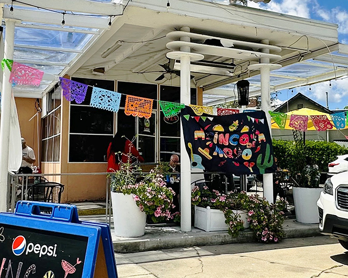 The colorful papel picado banners dancing above El Rincón's patio aren't just decoration—they're a promise that something worth celebrating awaits inside.