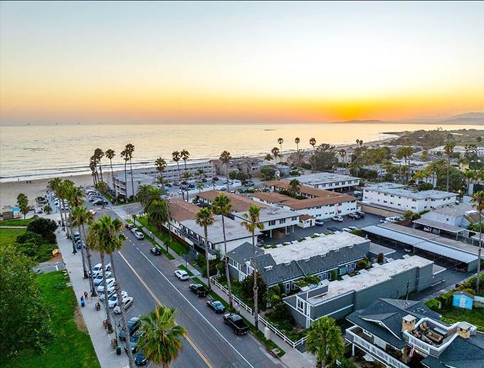 Sunset paints Carpinteria in golden hues, where palm trees stand like nature's exclamation points against the Pacific backdrop. California coastal living at its most sublime.