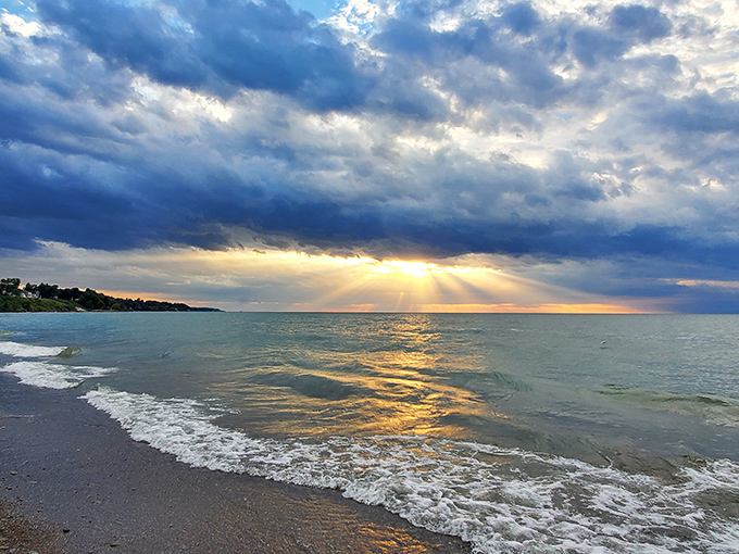The iconic lighthouse stands sentinel at the end of the breakwall, while colorful kites dance above Lake Erie's surprisingly Caribbean-blue waters.