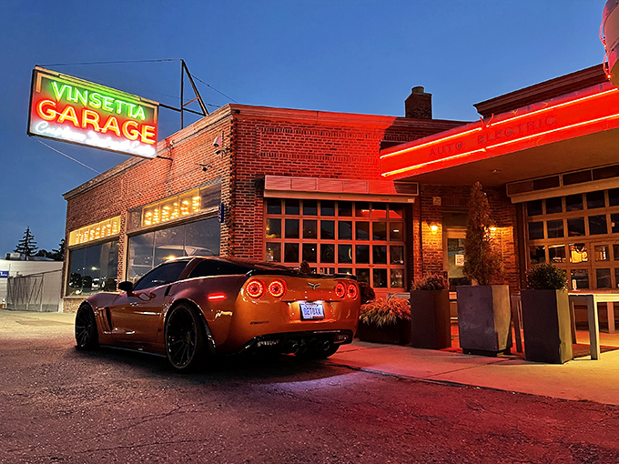 That neon glow against fresh snow isn't just a sign&mdash;it's a beacon calling hungry travelers home. Woodward Avenue's automotive shrine transforms into a culinary sanctuary after dark.