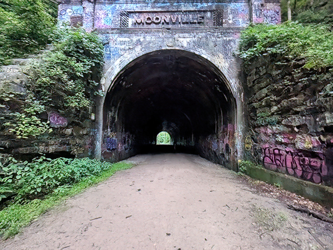 The entrance to Moonville Tunnel stands like a portal to another dimension, where graffiti meets history in a haunting embrace.