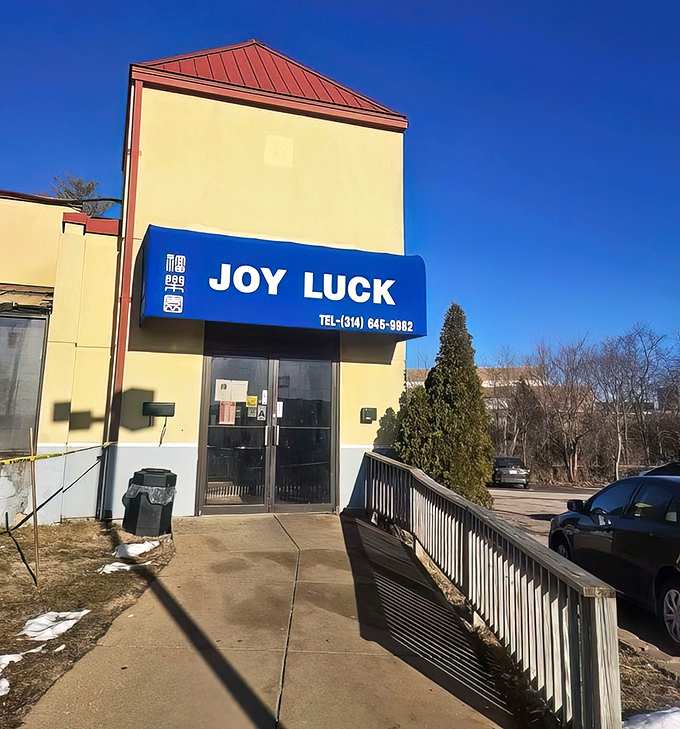 The blue awning of Joy Luck stands as a beacon of culinary promise, like finding a $20 bill in an old jacket pocket&mdash;unexpected but absolutely delightful.