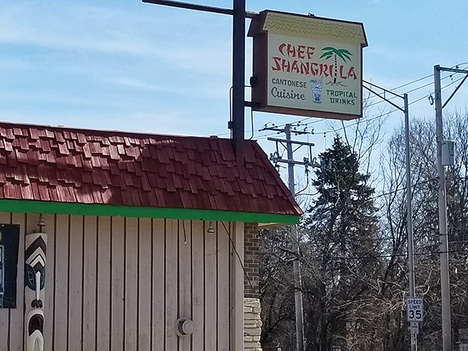 The unassuming exterior of Chef Shangri-La hides its tropical treasures like a suburban speakeasy. That turquoise chair is your first clue to paradise.