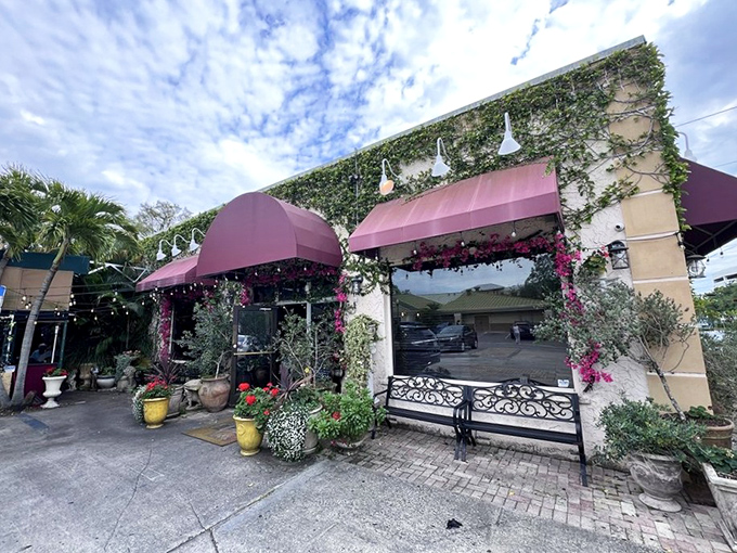The Mediterranean dream meets Florida sunshine at Cristino's, where that iconic arched sign promises coal-fired perfection waiting just beyond those doors.
