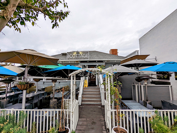 The quintessential California welcome! The Cottage's charming entrance, with its white trellis and climbing greenery, promises a breakfast experience worth writing home about.