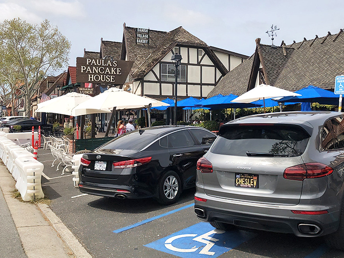 The iconic wooden sign beckons breakfast lovers like a siren call. Danish architecture and blue umbrellas promise a European morning in California wine country.