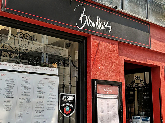 The vibrant red exterior of Brenda's stands out like a culinary beacon in San Francisco's Tenderloin district, promising Southern comfort with French flair.