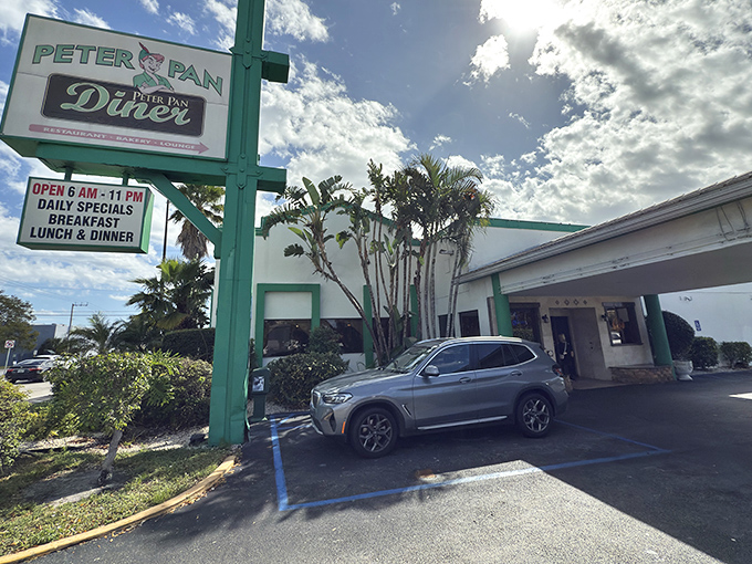 The iconic green pillars of Peter Pan Diner stand like sentinels guarding a treasure trove of comfort food classics in Oakland Park.