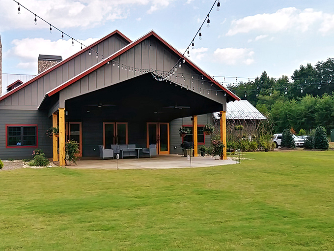 The rustic lodge exterior of Saskatoon welcomes hungry travelers with its dramatic peaked roof and American flag. Wilderness dining awaits beyond those wooden doors.