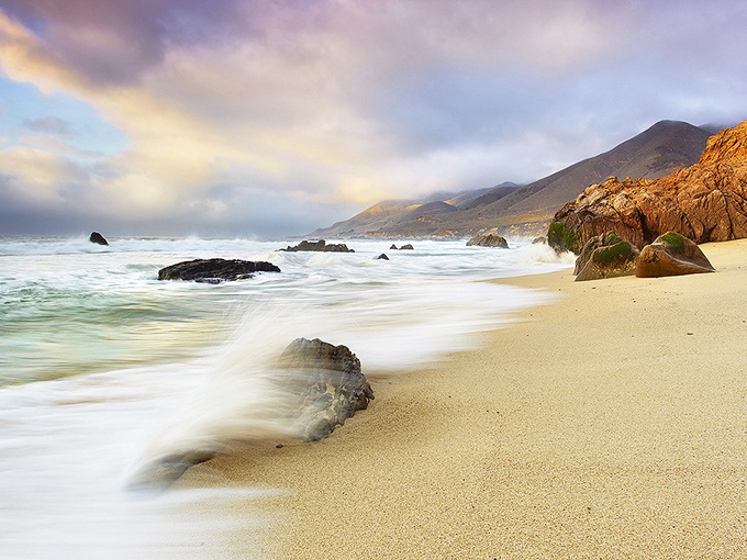 Nature's masterpiece unfolds where golden sand meets rugged cliffs. The morning light transforms Garrapata's coastline into a painting you can walk through.