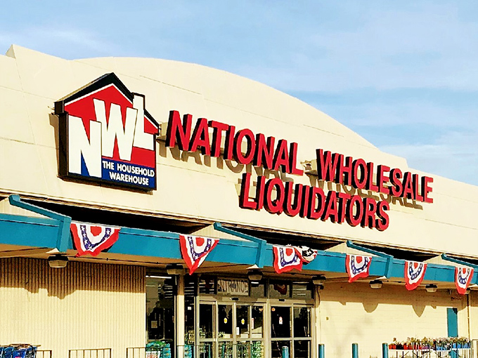 The iconic red, white, and blue sign beckons bargain hunters like a retail lighthouse. National Wholesale Liquidators stands ready to transform shopping lists into treasure maps.