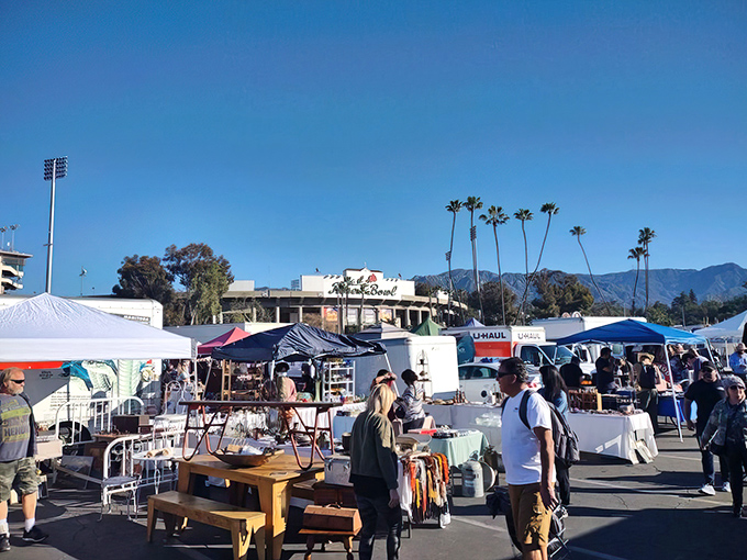 The iconic Rose Bowl Stadium transforms into a treasure hunter's paradise once a month, where pink blossoms and blue skies frame California's ultimate shopping adventure.