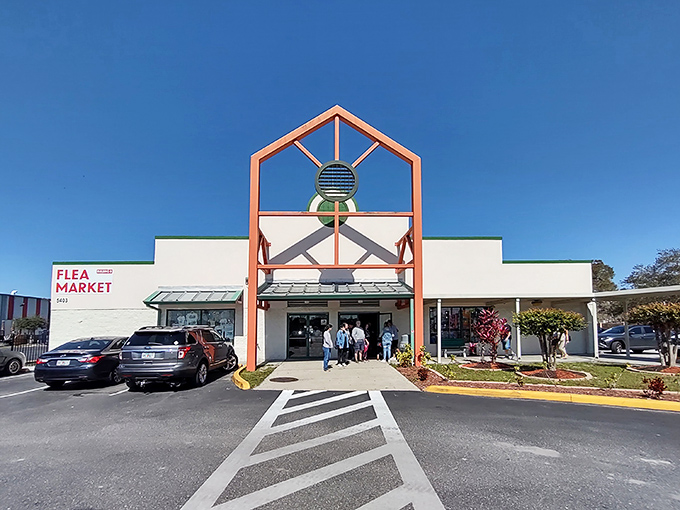 The iconic coral-colored entrance sign promises two of life's greatest pleasures: bargain hunting and street food. Florida's blue skies provide the perfect backdrop.