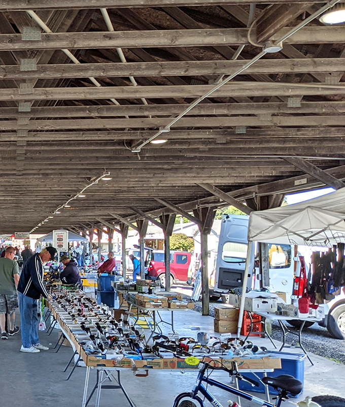 Under weathered wooden beams, treasure hunters scan tables laden with tools and gadgets. This covered pavilion shields bargain-seekers from Ohio's unpredictable elements while they hunt for deals.