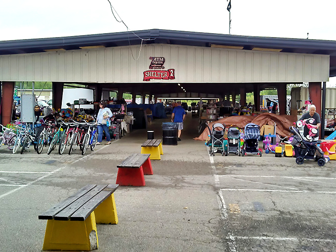 The covered outdoor section at Treasure Aisles welcomes bargain hunters with colorful benches and an eclectic array of merchandise from bikes to baby strollers.