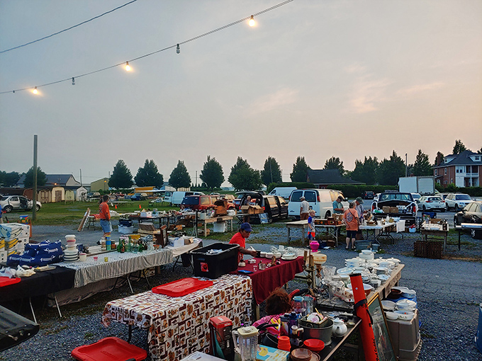 Twilight transforms Root's into a magical bazaar where string lights illuminate treasure hunters scouring tables for that perfect find. The thrill of discovery hangs in the evening air.