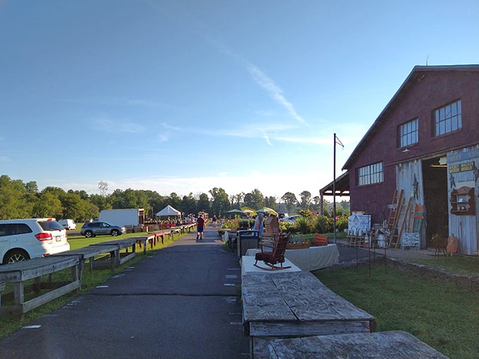 The iconic red barn welcomes early birds and treasure hunters alike. Morning light bathes the path to Pennsylvania's premier flea market adventure.