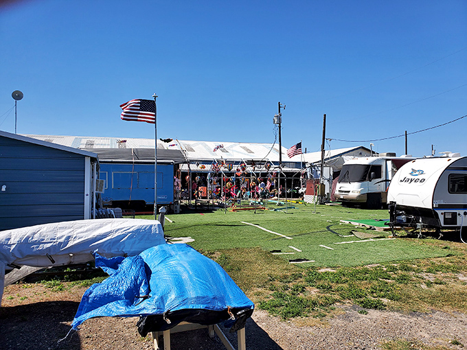 American flags flutter above a sprawling marketplace where RVs and tents create the perfect backdrop for treasure hunting adventures in the Texas sun.