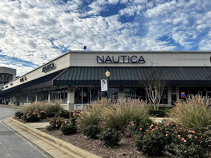 The iconic cream-colored facades with green awnings welcome bargain hunters to Carolina Premium Outlets, where retail therapy meets actual savings.