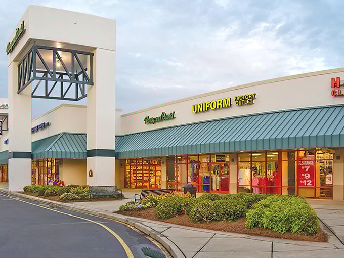 The iconic cream-colored facades with green awnings welcome bargain hunters to Carolina Premium Outlets, where retail therapy meets actual savings.