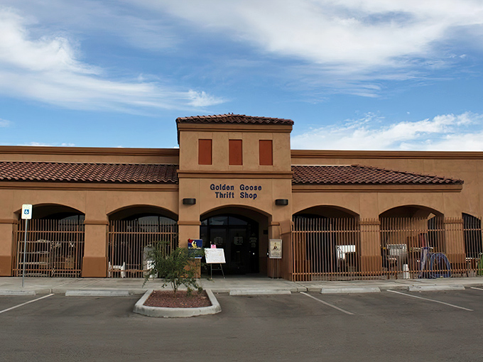 The stucco facade of Golden Goose Thrift Shop beckons like a desert mirage, promising treasures within its Spanish-style walls.