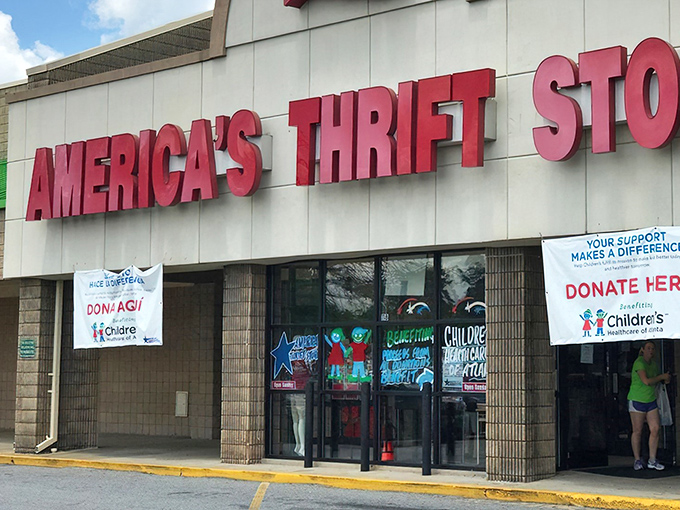 The iconic red signage of America's Thrift Store beckons bargain hunters like a retail lighthouse guiding ships to treasure-filled shores.