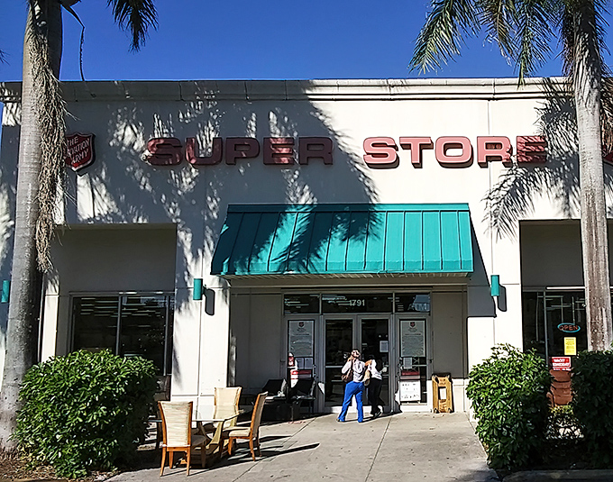Palm trees stand guard like tropical bouncers at this bargain hunter's paradise. The Salvation Army Super Store promises treasure hunting under Florida's blue skies.