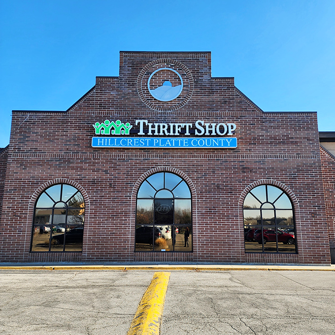 The stately brick fa&ccedil;ade of Hillcrest Thrift Shop stands proudly against a blue Missouri sky, promising treasure hunters adventures that await inside.