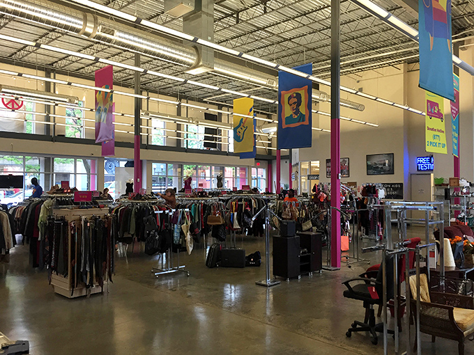 The sprawling interior of Out of the Closet feels more like a well-organized department store than a typical thrift shop, with colorful banners adding a festive touch to the high ceilings. 