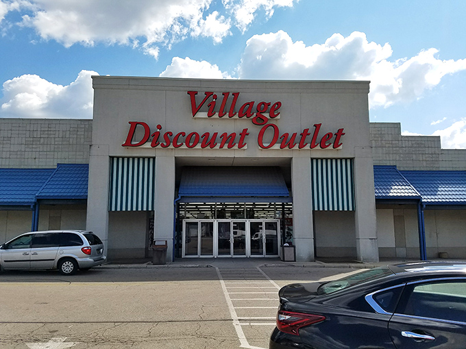 The iconic red lettering of Village Discount Outlet beckons like a siren call to bargain hunters across Dayton. Treasure awaits inside!