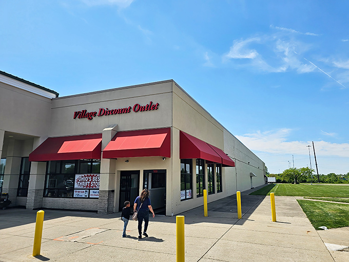 The iconic red awnings of Village Discount Outlet beckon bargain hunters like a retail lighthouse guiding ships to treasure-filled shores.