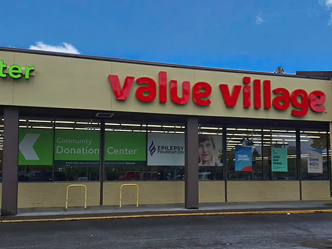 The iconic red Value Village sign beckons like a lighthouse to shipwrecked shoppers tired of paying full retail prices.