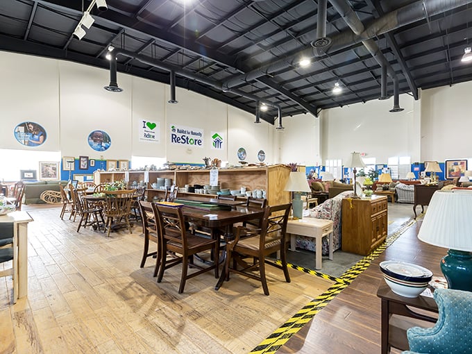 The furniture section at Habitat ReStore stretches out like a well-organized treasure map. Quality dining sets await their second chance at hosting family gatherings.
