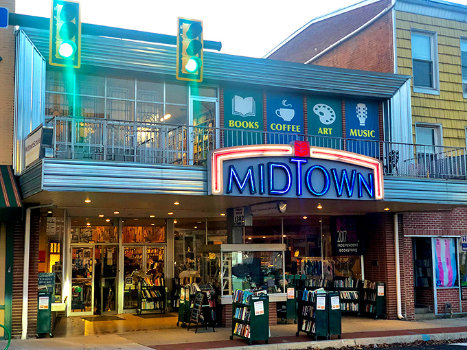 The iconic Midtown Scholar storefront glows like a literary lighthouse in Harrisburg's evening hours, beckoning bibliophiles with promises of endless discovery.