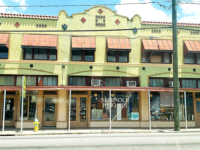 The historic Spanish-influenced façade of Retro Mania Vintage Market stands as a time capsule on Tampa's streets, copper awnings telling stories of decades past.