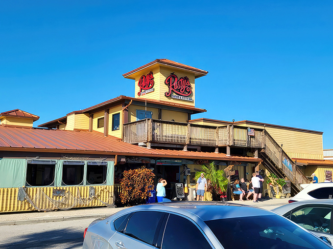 The sunshine-yellow exterior of Rusty's stands like a beacon for seafood lovers, promising coastal delights with that unmistakable Old Florida charm.