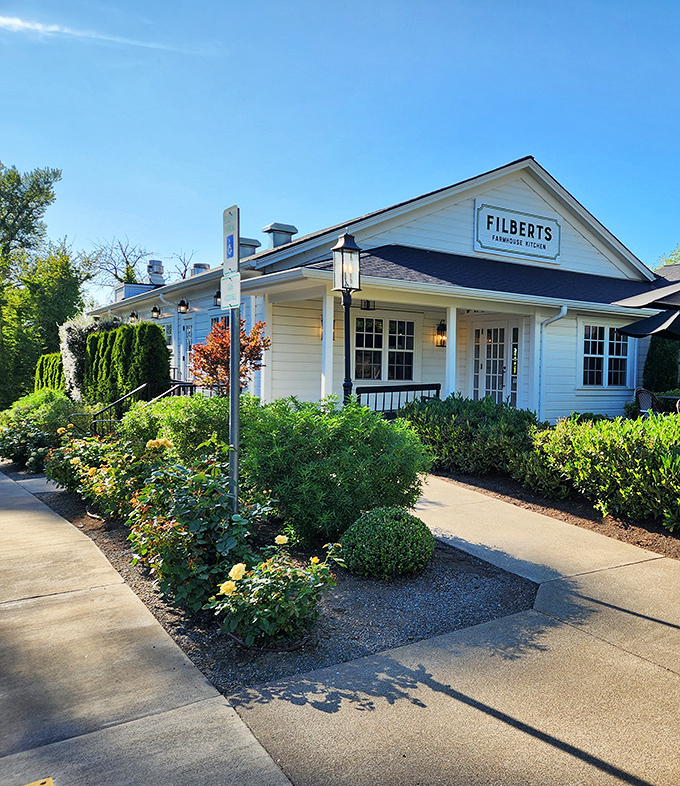The white farmhouse exterior of Filberts welcomes you like a warm hug, complete with yellow roses that seem to whisper, "Come in, stay awhile."
